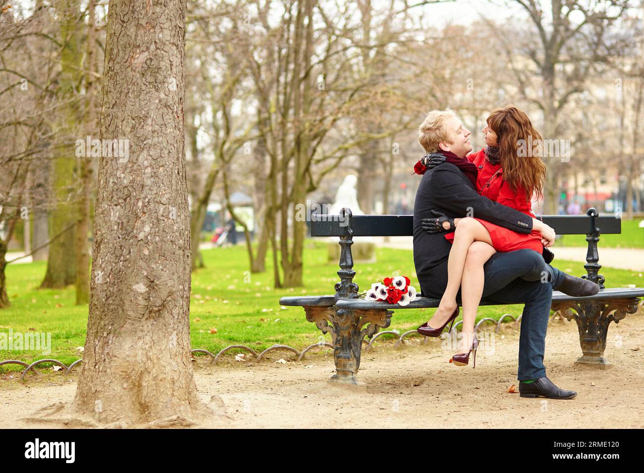 Romantic couple in a park at spring, dating Stock Photo - Alamy