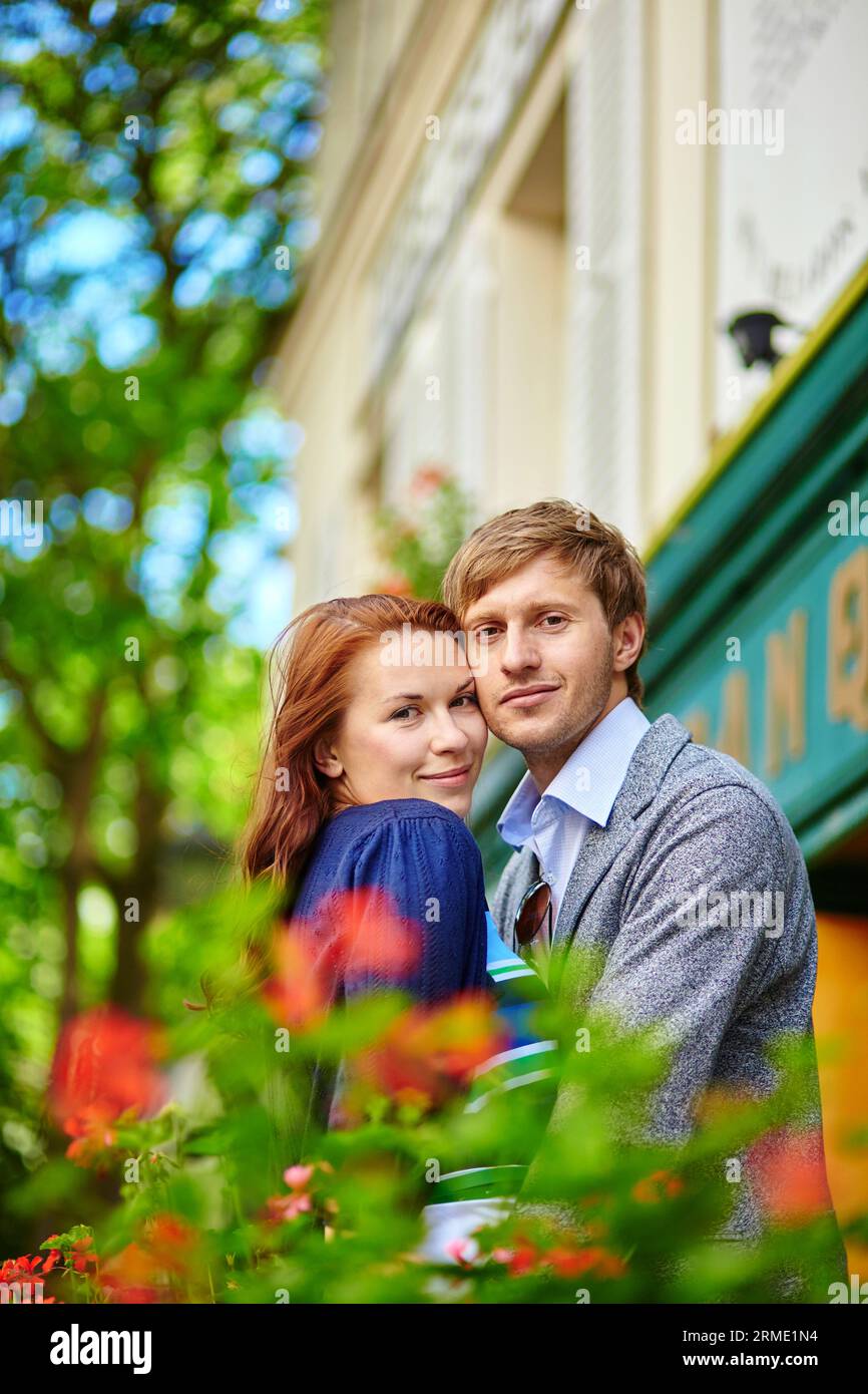 Romantic couple together on balcony of a house or hotel with blossoming ...