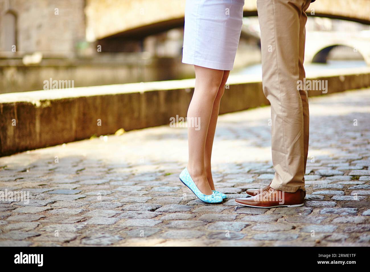 Closeup of male and female legs during a date Stock Photo - Alamy