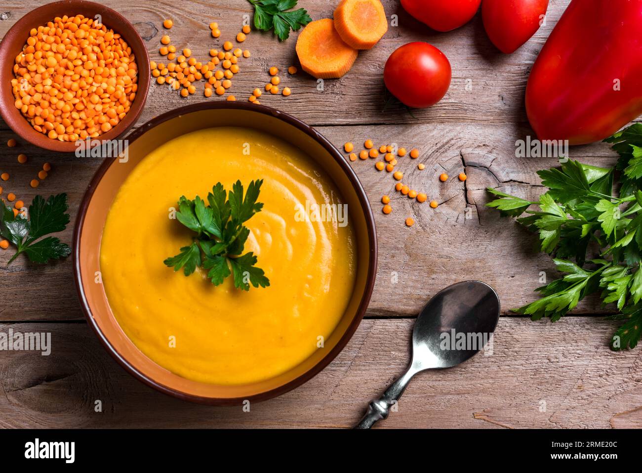 Red lentil and vegetable soup on wooden background. Traditional middle ...