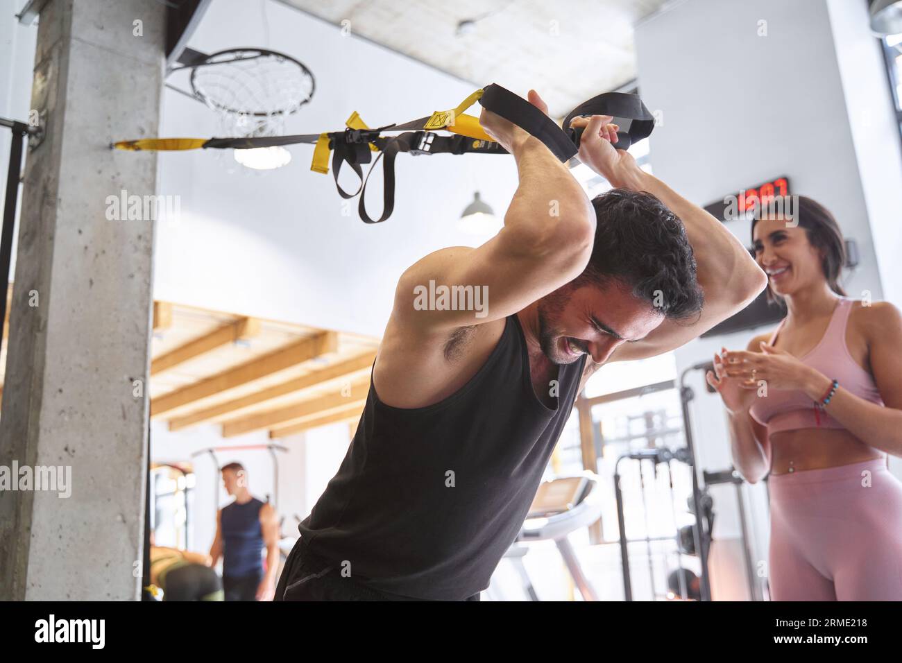 Fitness man exercising with suspension straps at the gym. Sports ...