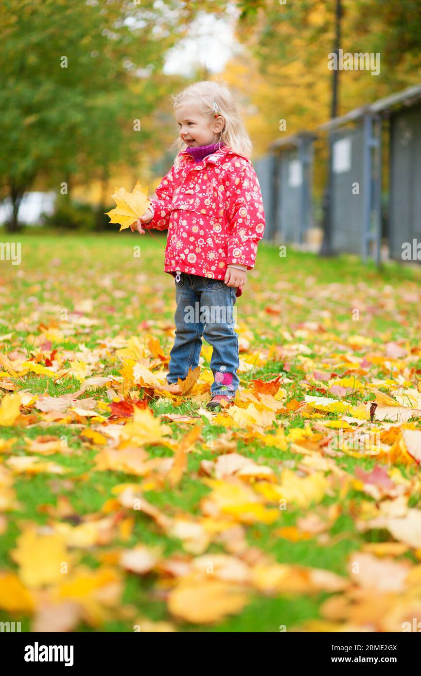 Adorable little girl enjoying beautiful fall day Stock Photo - Alamy