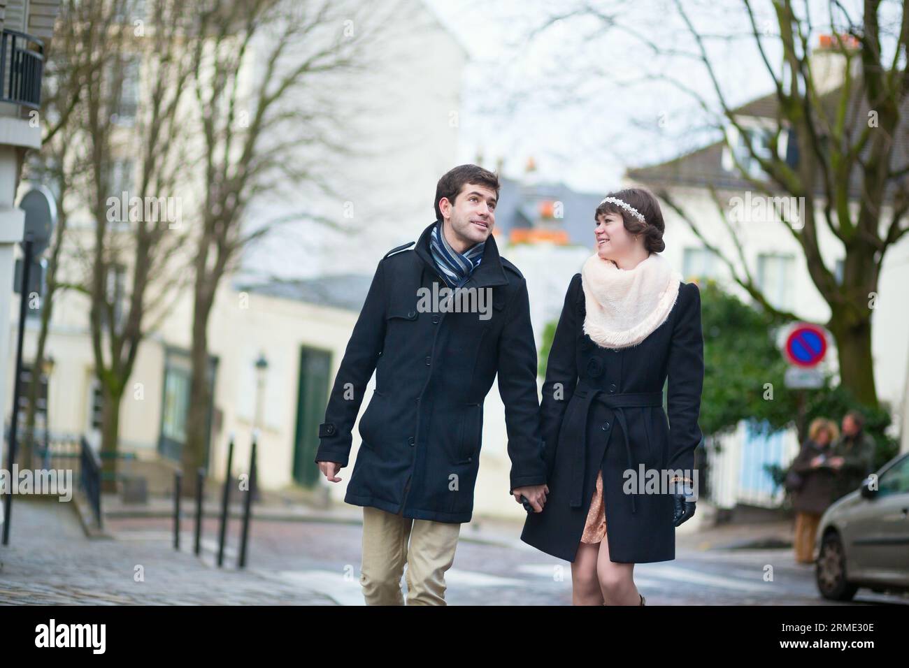 Happy couple having a walk in Paris Stock Photo - Alamy
