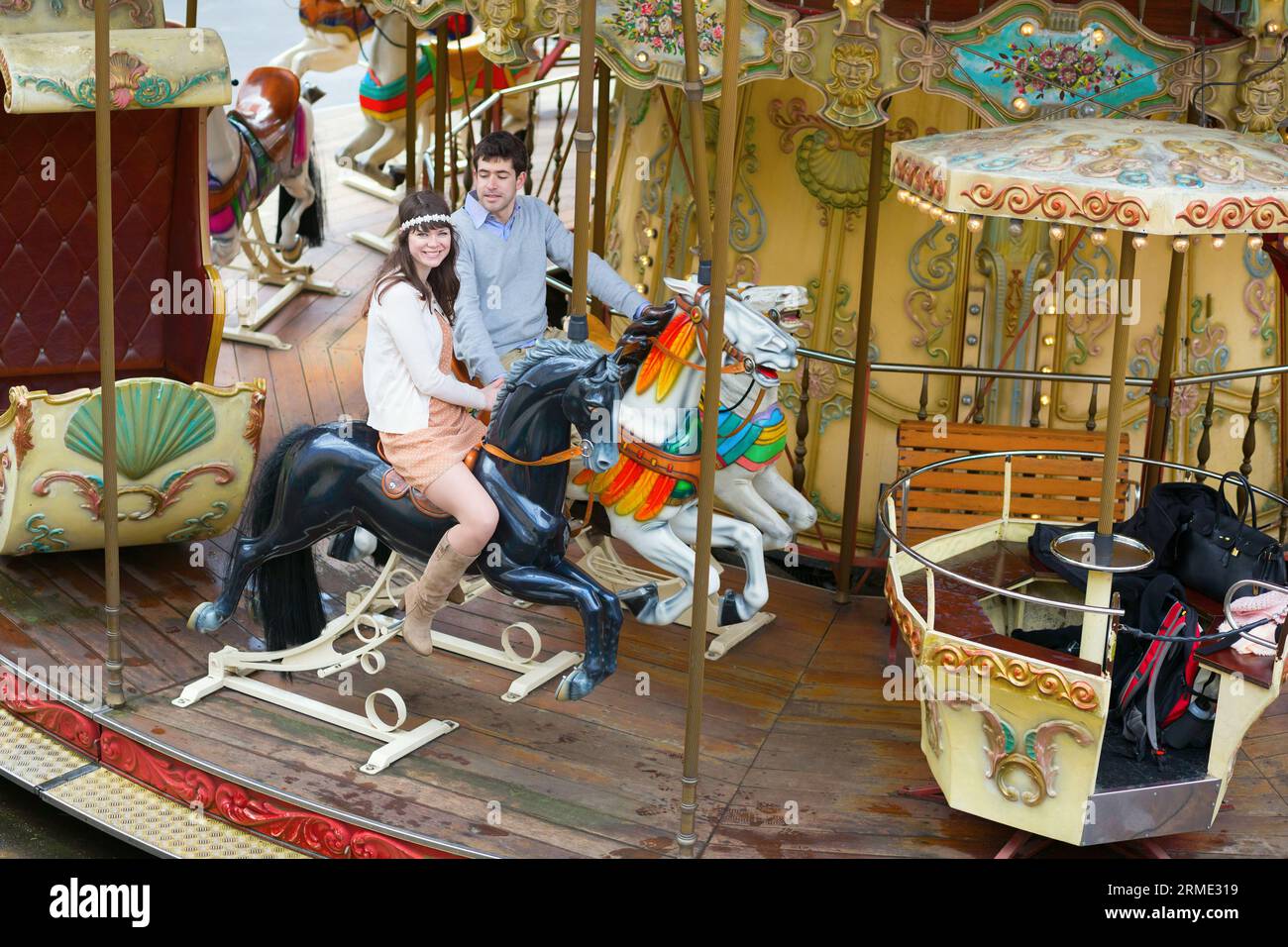 Adult man and woman on merry go round carousel hi-res stock photography and images - Alamy