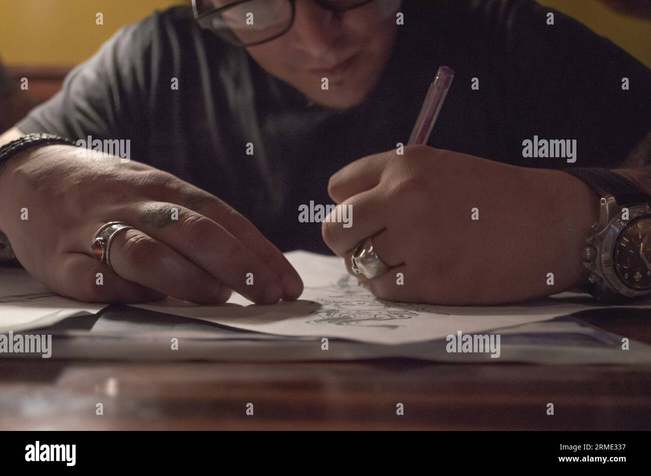 Man drawing for tattoo Stock Photo - Alamy