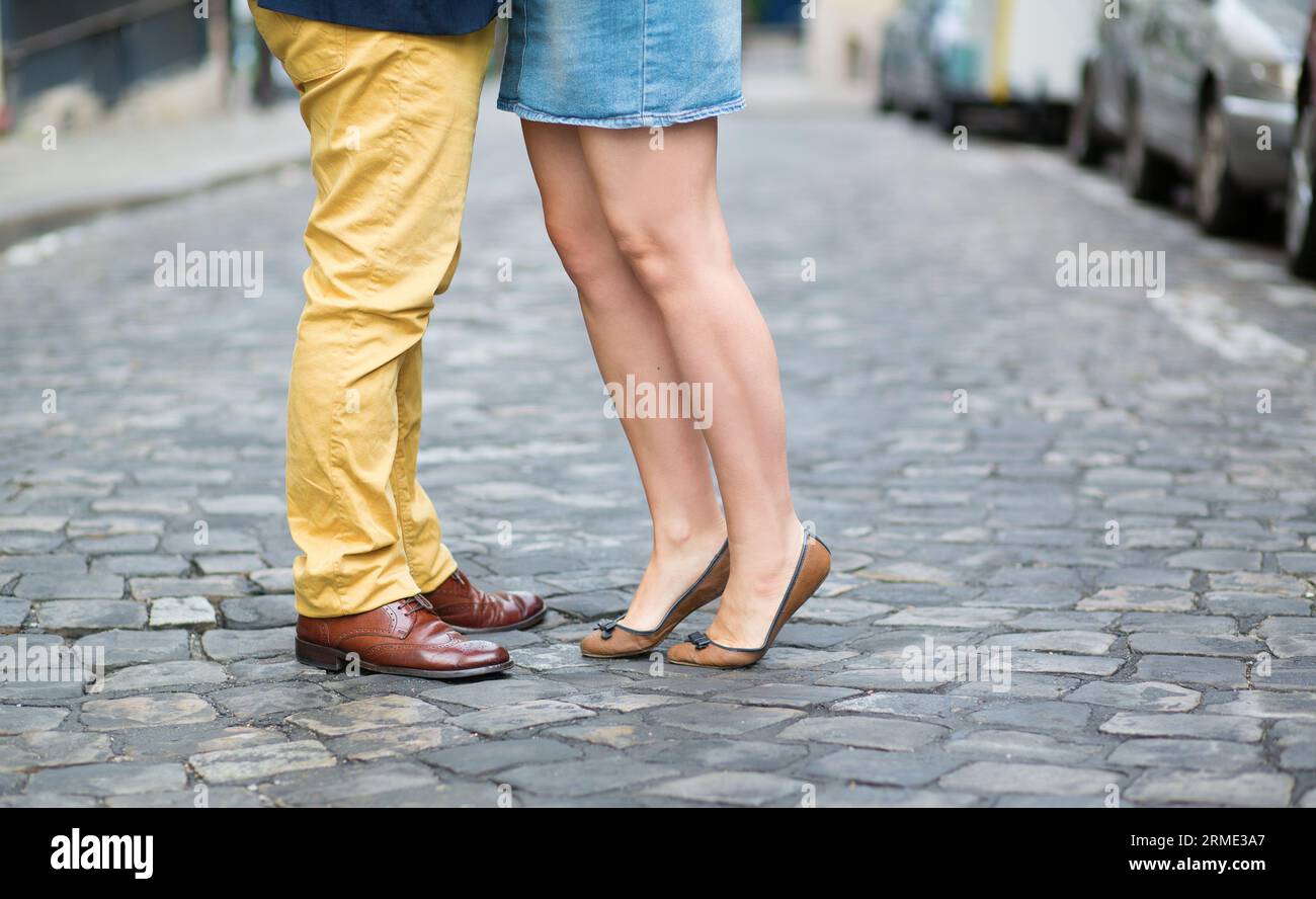 Closeup of male and female legs during a date Stock Photo - Alamy