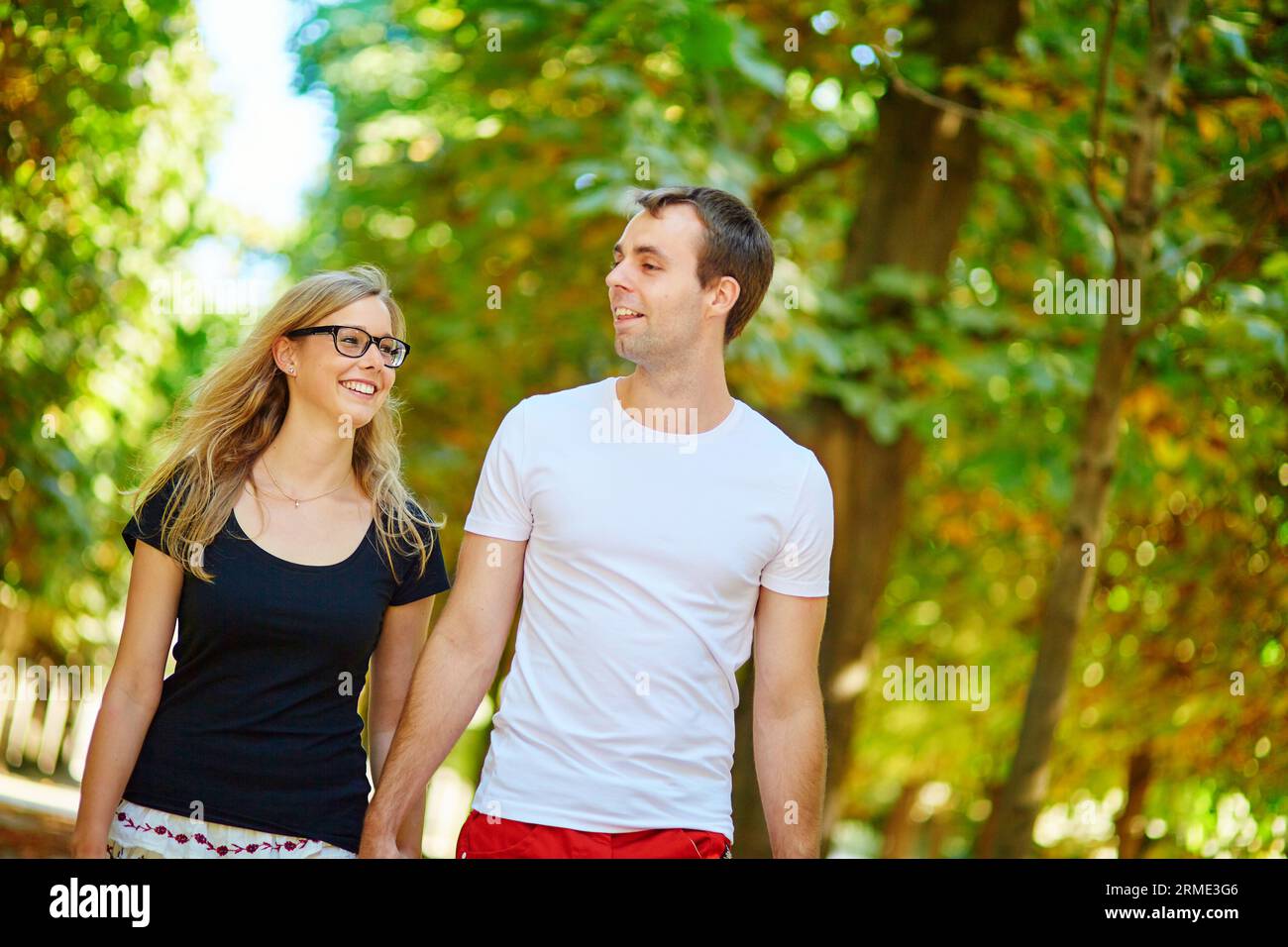 Male student walking urban park hi-res stock photography and images - Alamy