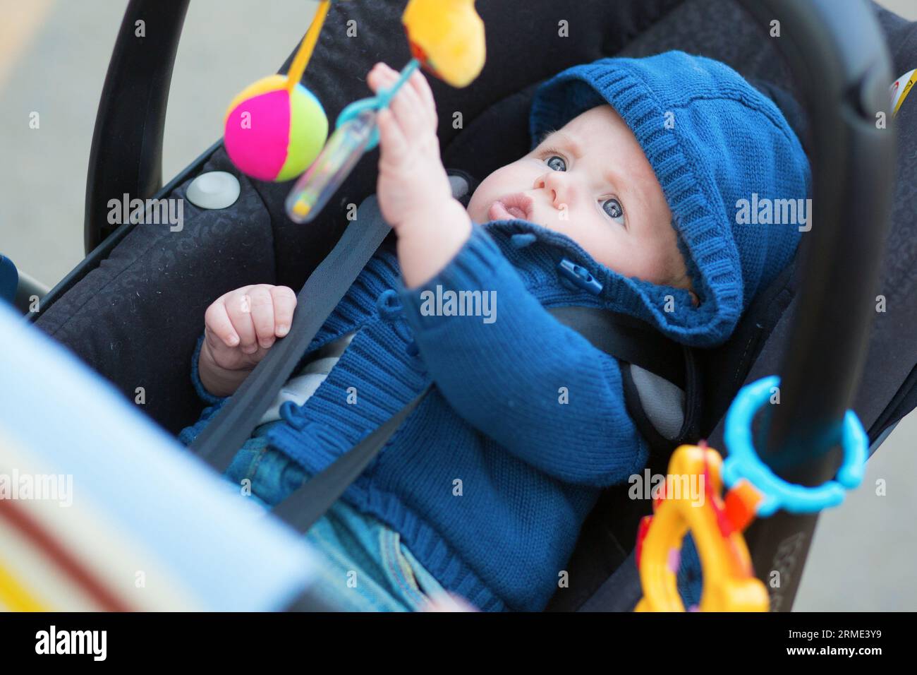 Adorable little baby boy in a stroller Stock Photo - Alamy