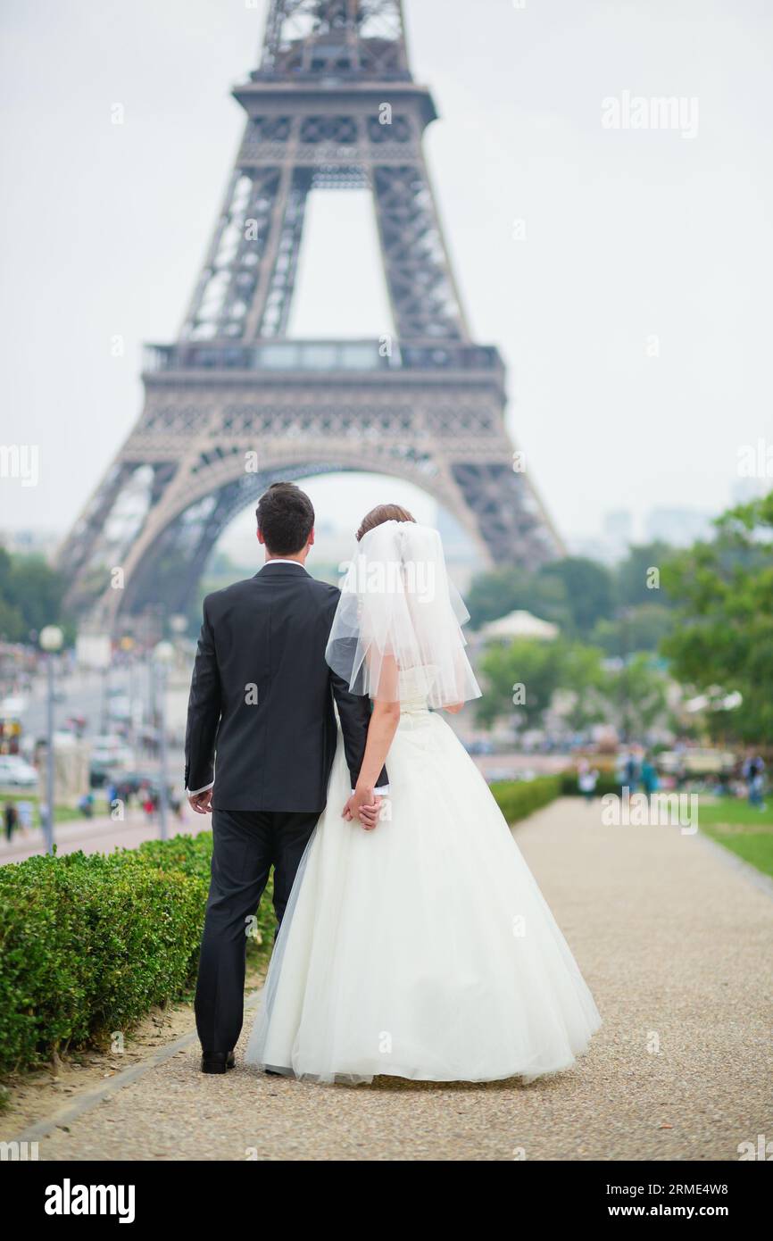 Happy just married couple in Paris, looking at the Eiffel tower Stock ...