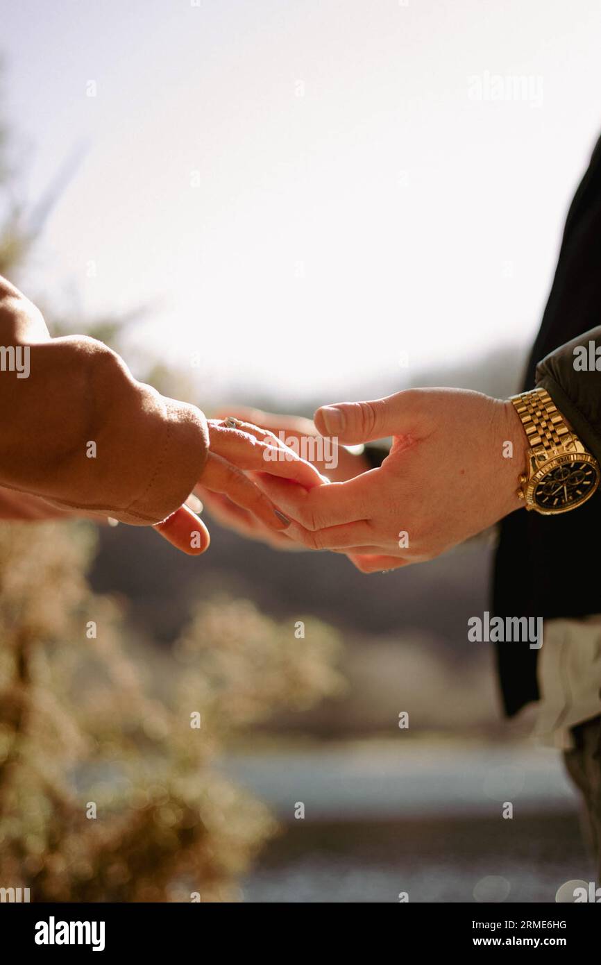 Couples' hands touch in a glowing golden light, loving connection Stock ...