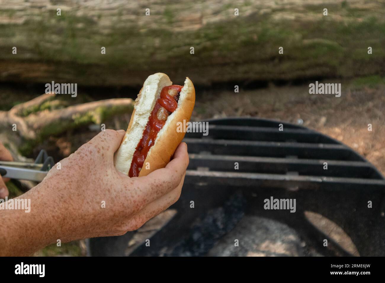 Grilling a hot dog with ketchup at campsite BBQ Stock Photo - Alamy