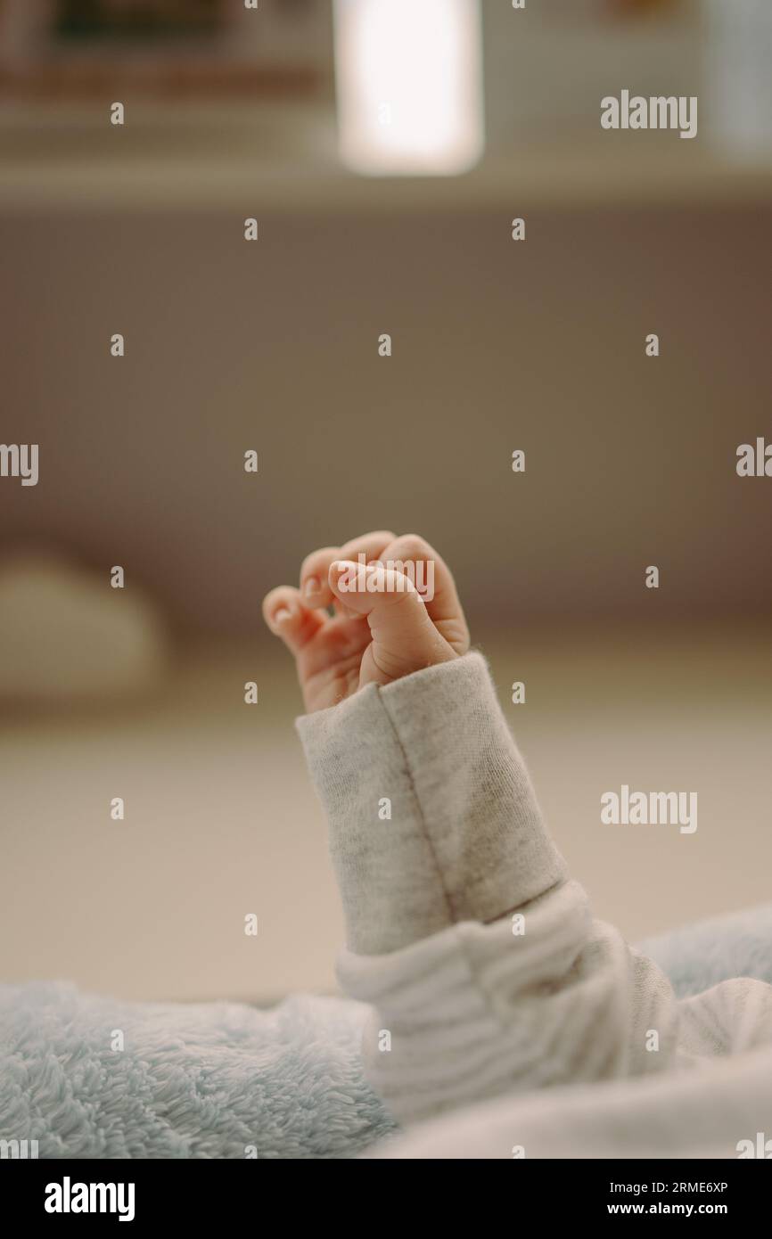 newborn baby hand reaches up from the crib, exploring Stock Photo - Alamy
