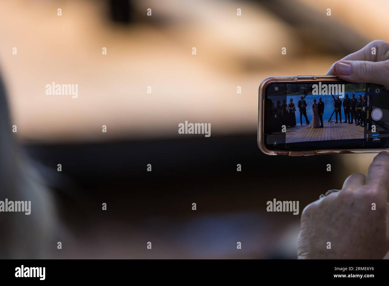 Loved one capturing wedding joy on phone screen, heartfelt moment Stock ...