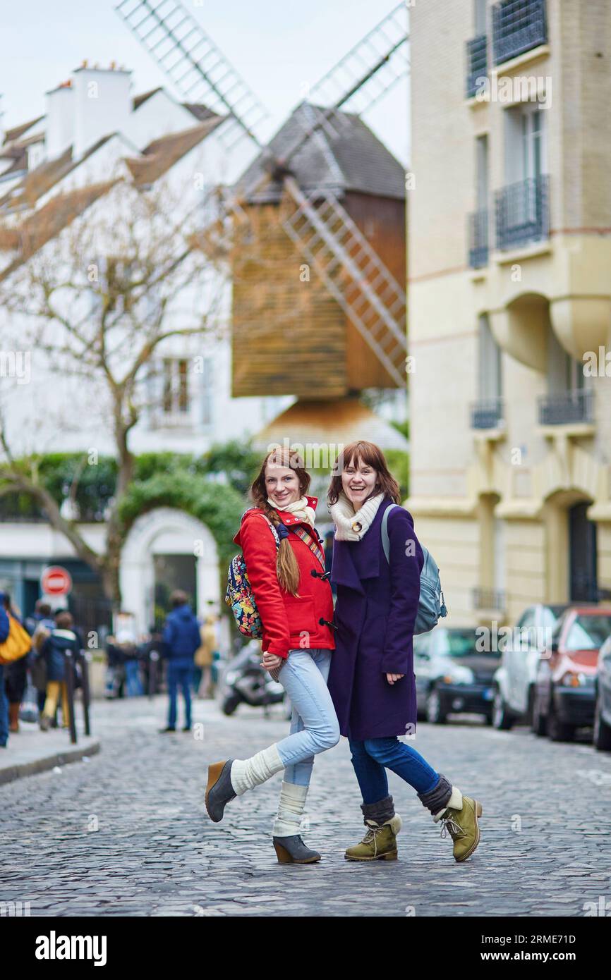 Two cheerful beautiful girls in Paris, having fun on Montmartre Stock ...