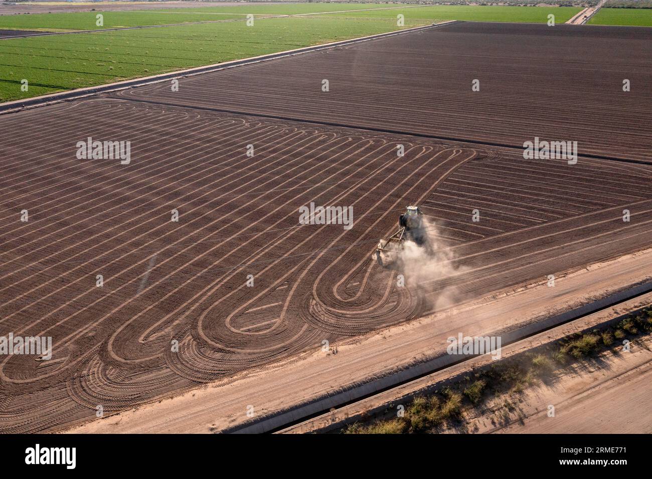 Aerial view of tractor making patterns in dry dirt and dust Stock Photo ...