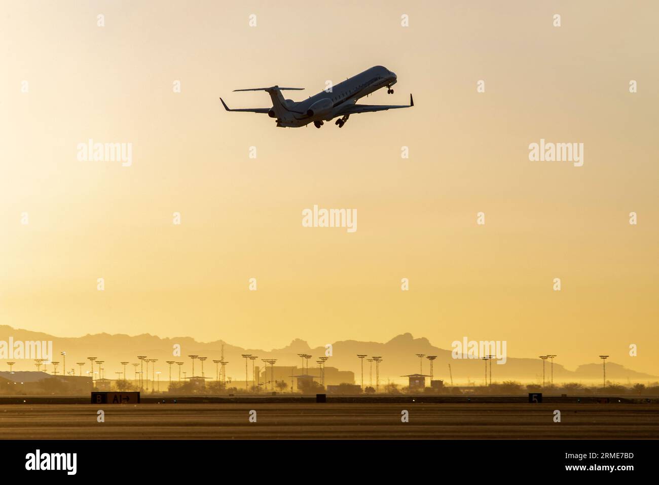 Plane taking off from airport early morning light Stock Photo - Alamy