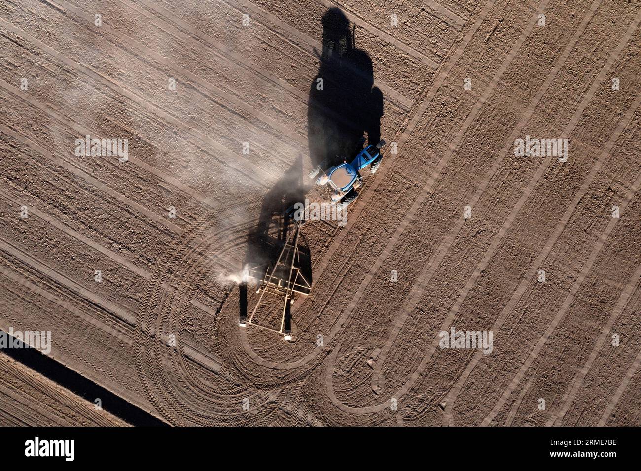 View straight overhead of tractor casting shadow Stock Photo - Alamy