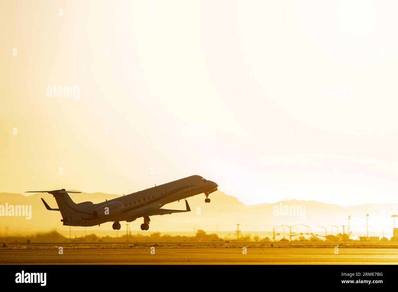 Plane taking off from airport strong early morning light Stock Photo ...