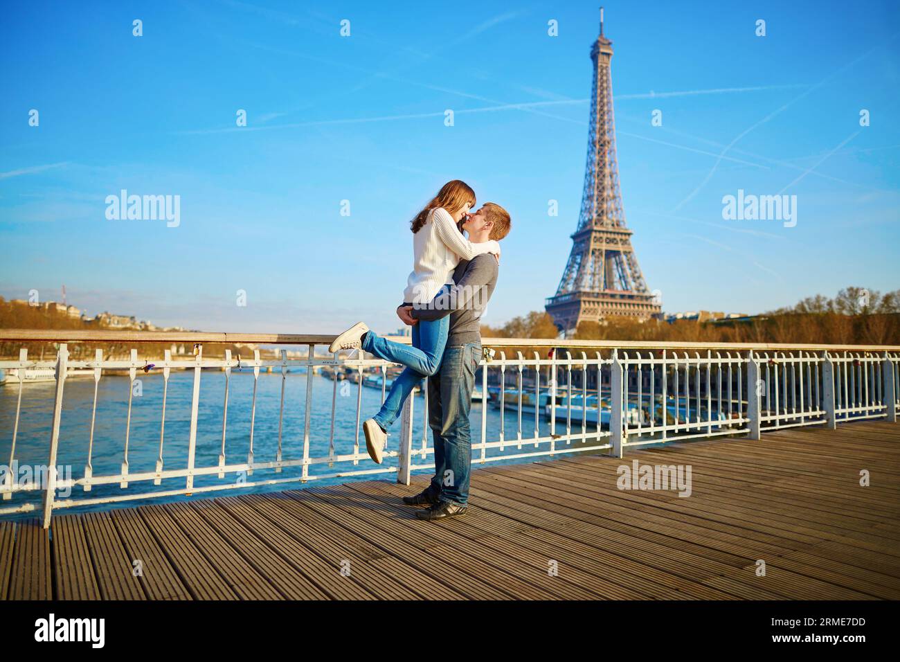 Romantic couple having fun near the Eifel tower and kissing Stock Photo ...