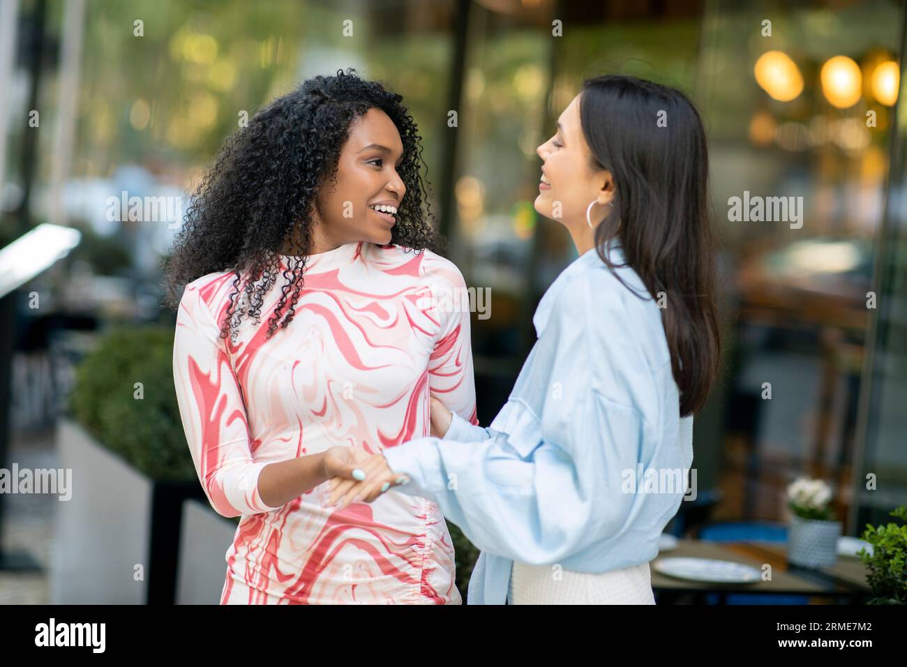 Happy Multiethnic Female Friends Greeting Each Other After Meeting ...