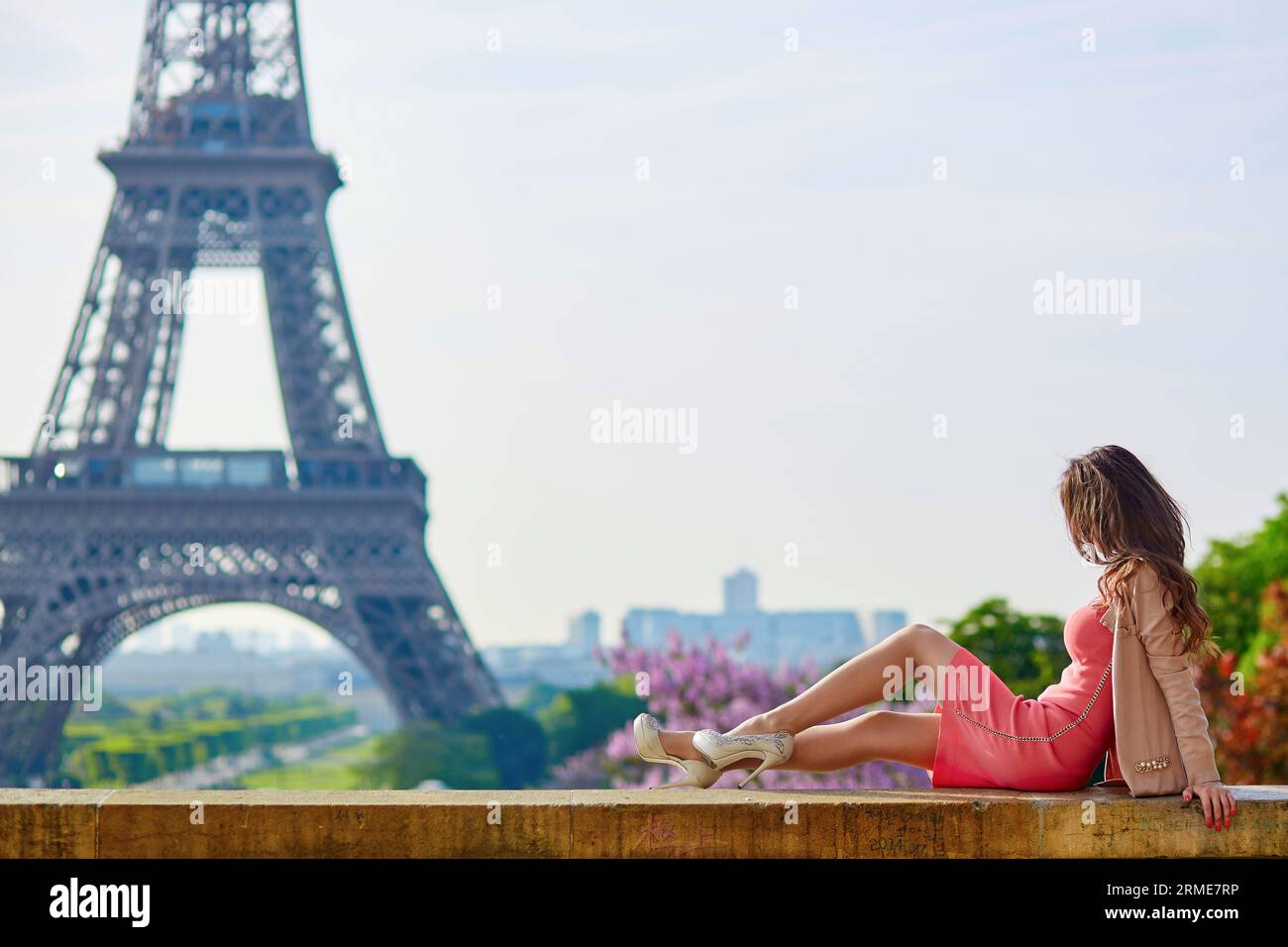 Young beautiful and elegant Parisian woman in pink dress on the high ...