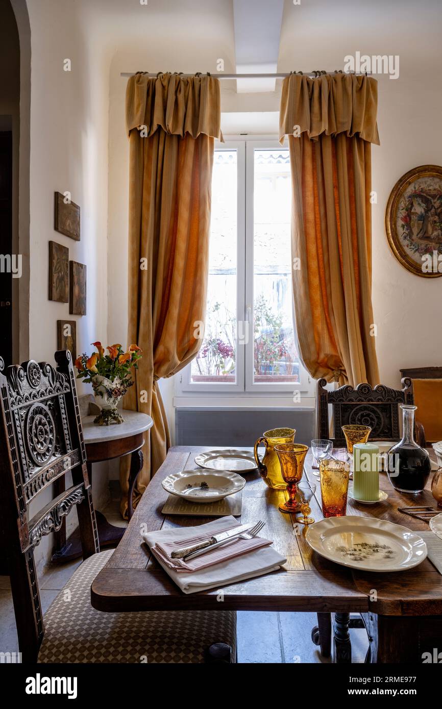 Antique Biot glassware with amber tones in Cotignac dining room, Var ...