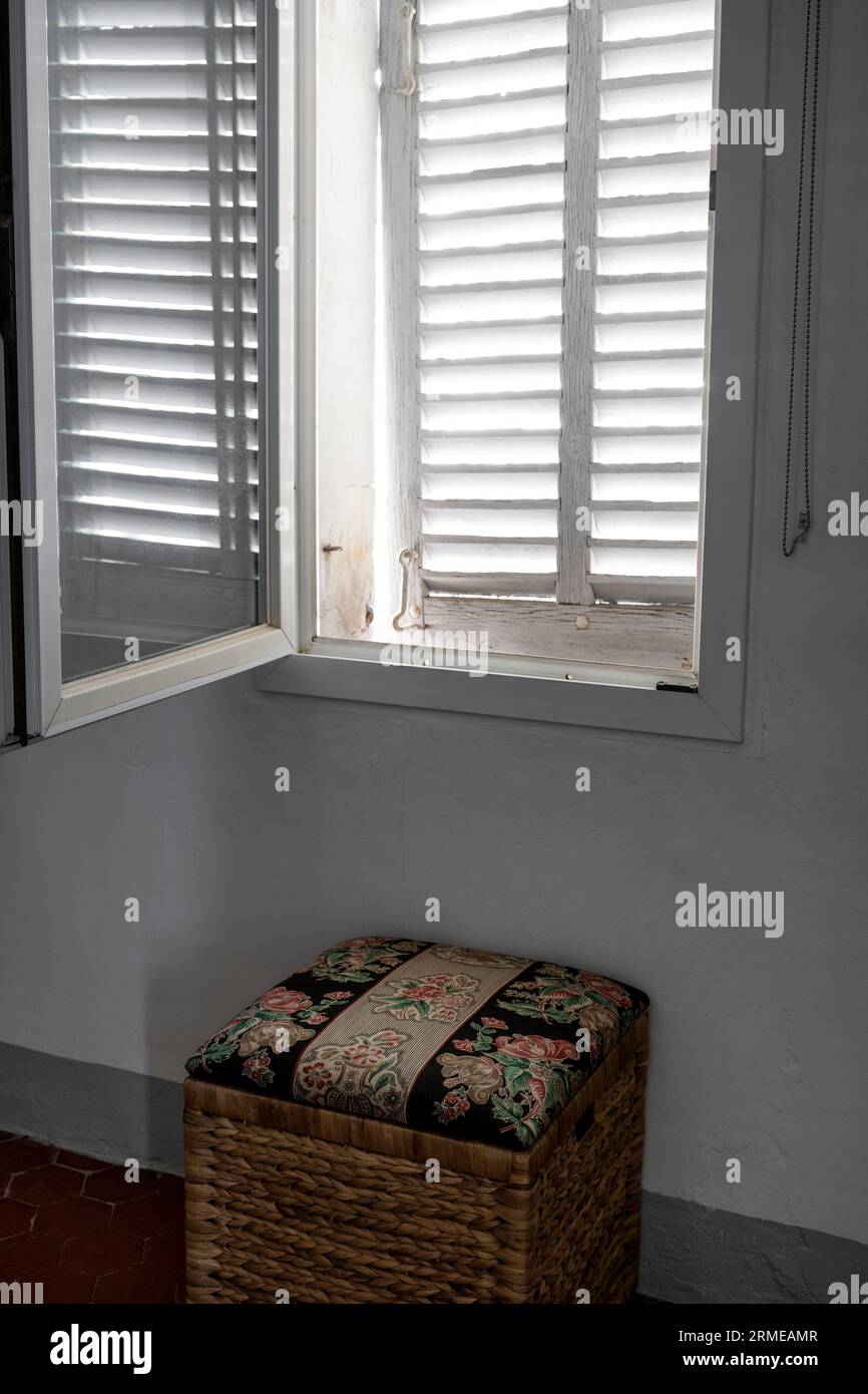 Rattan storage box with antique tapestry lid under window in Cotignac ...
