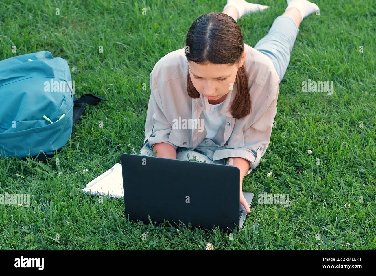 Teenage schoolgirl studying reading her books, tablet and notebook ...
