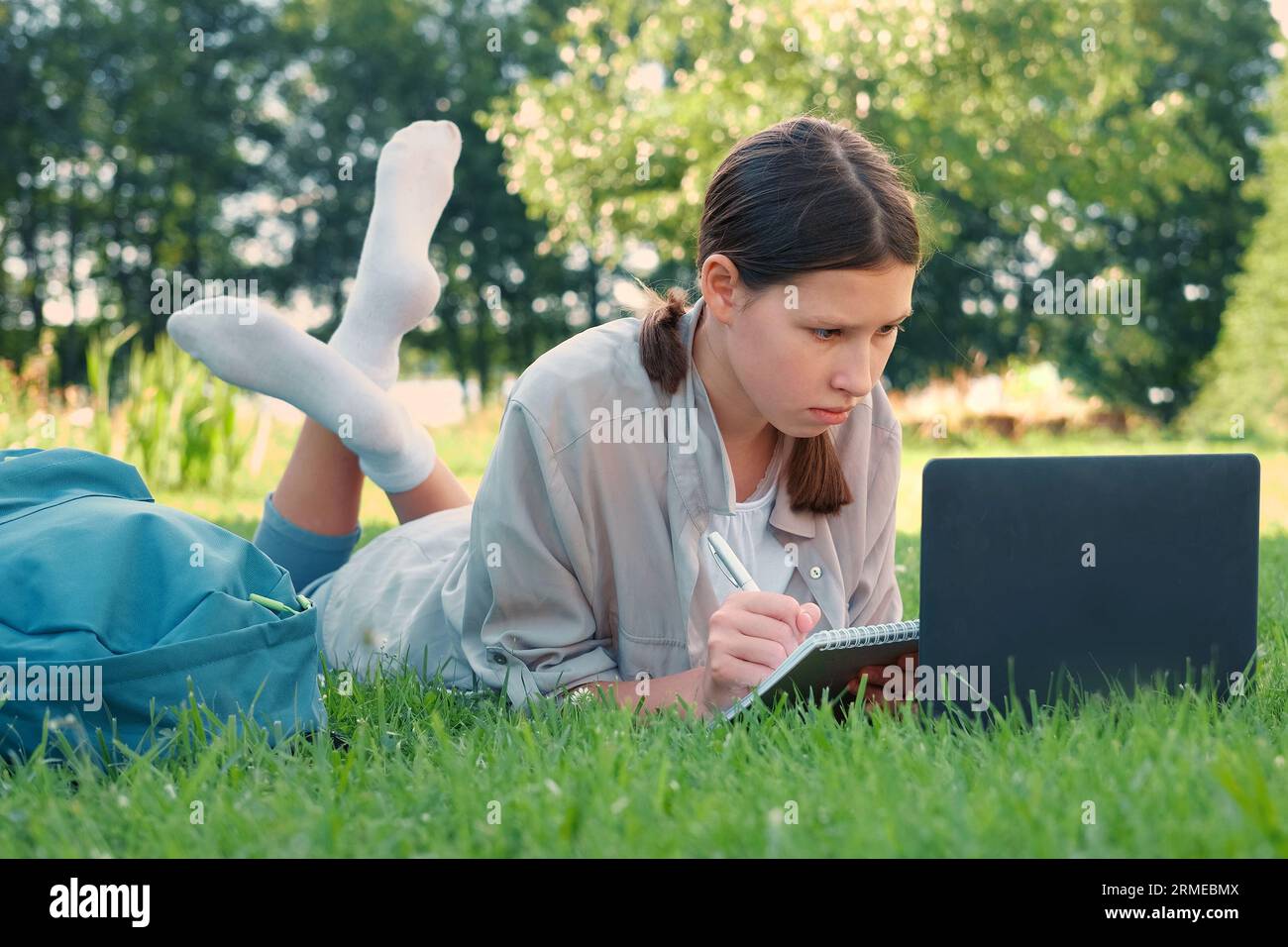 Teenage schoolgirl studying reading her books, tablet and notebook ...