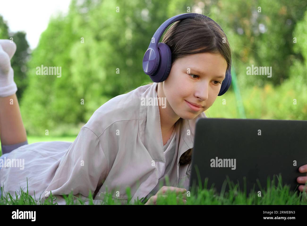 Teenage schoolgirl studying reading her books, tablet and notebook ...