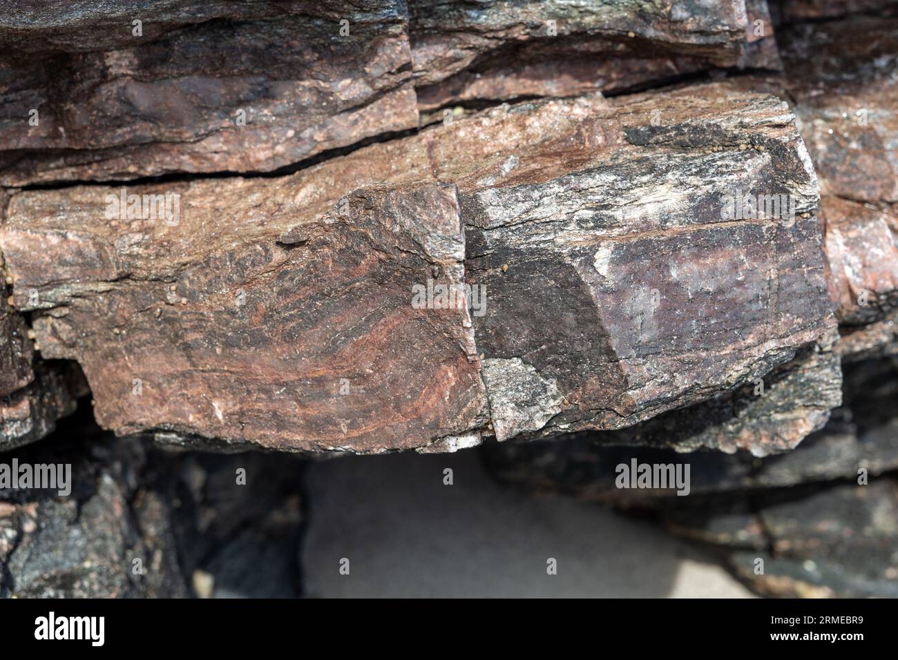 Bands of red laterite rock (iron from vegetation)in basaltic lava flow ...