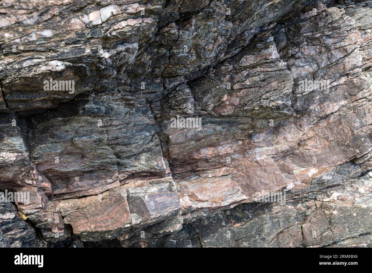 Bands of red laterite rock (iron from vegetation)in basaltic lava flow ...