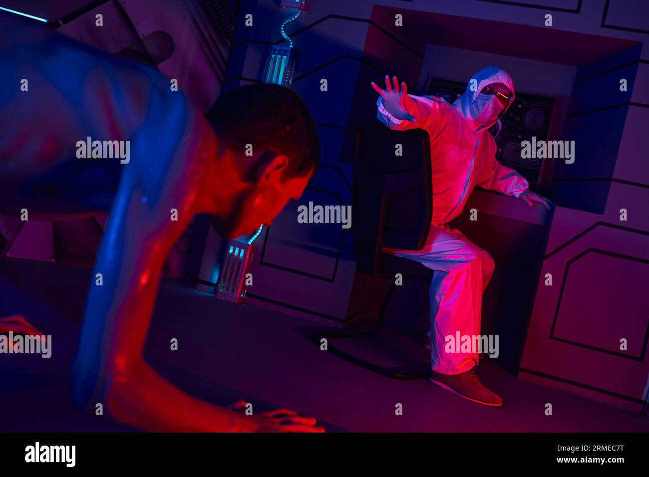 extraterrestrial humanoid crawling near scientist in hazmat suit ...