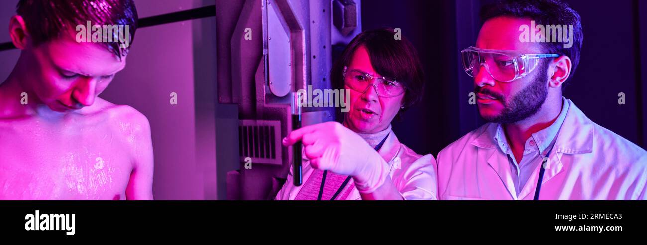 scientist holding test tube with alien blood sample near indian ...