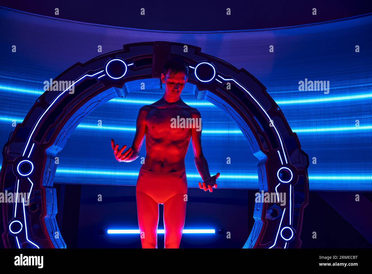 cosmic creature, humanoid alien looking at hands in experimental device ...