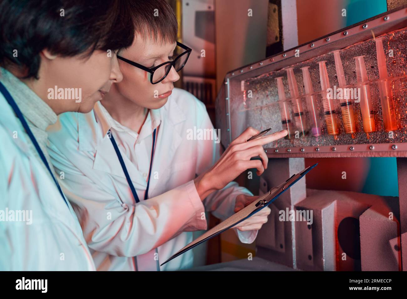 cosmic exploration, intern pointing at test tubes with extraterrestrial ...