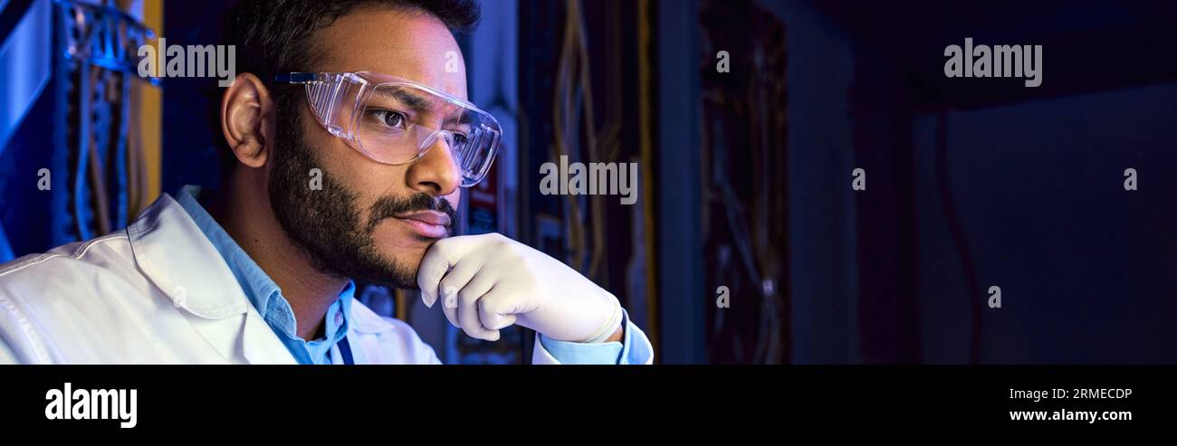 thoughtful indian scientist in goggles and latex glove in science ...