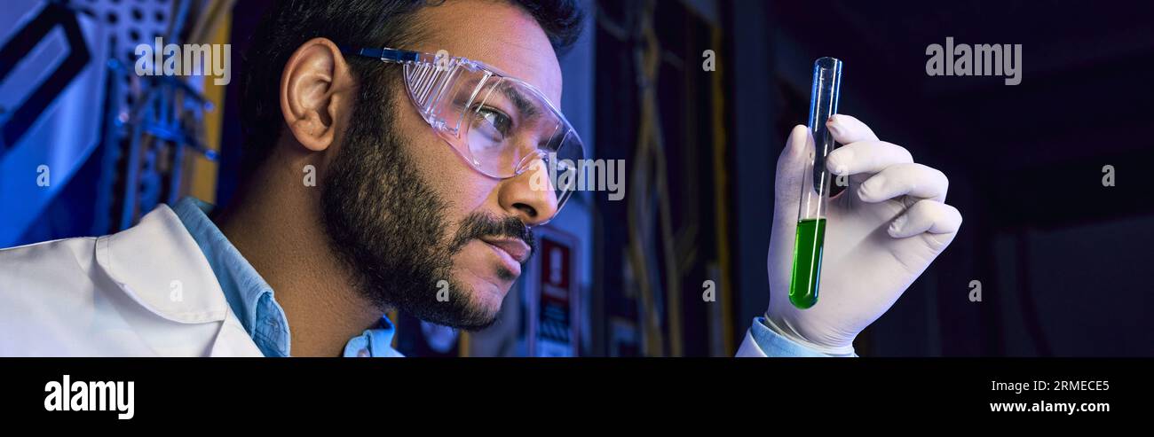 future science, indian scientist in goggles looking at sample in test ...