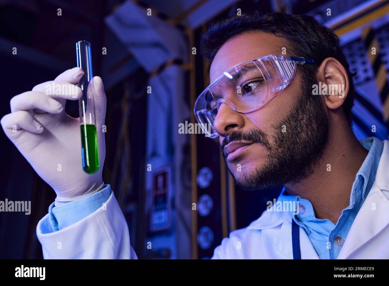 exploring universe, indian scientist in goggles holding test tube with ...
