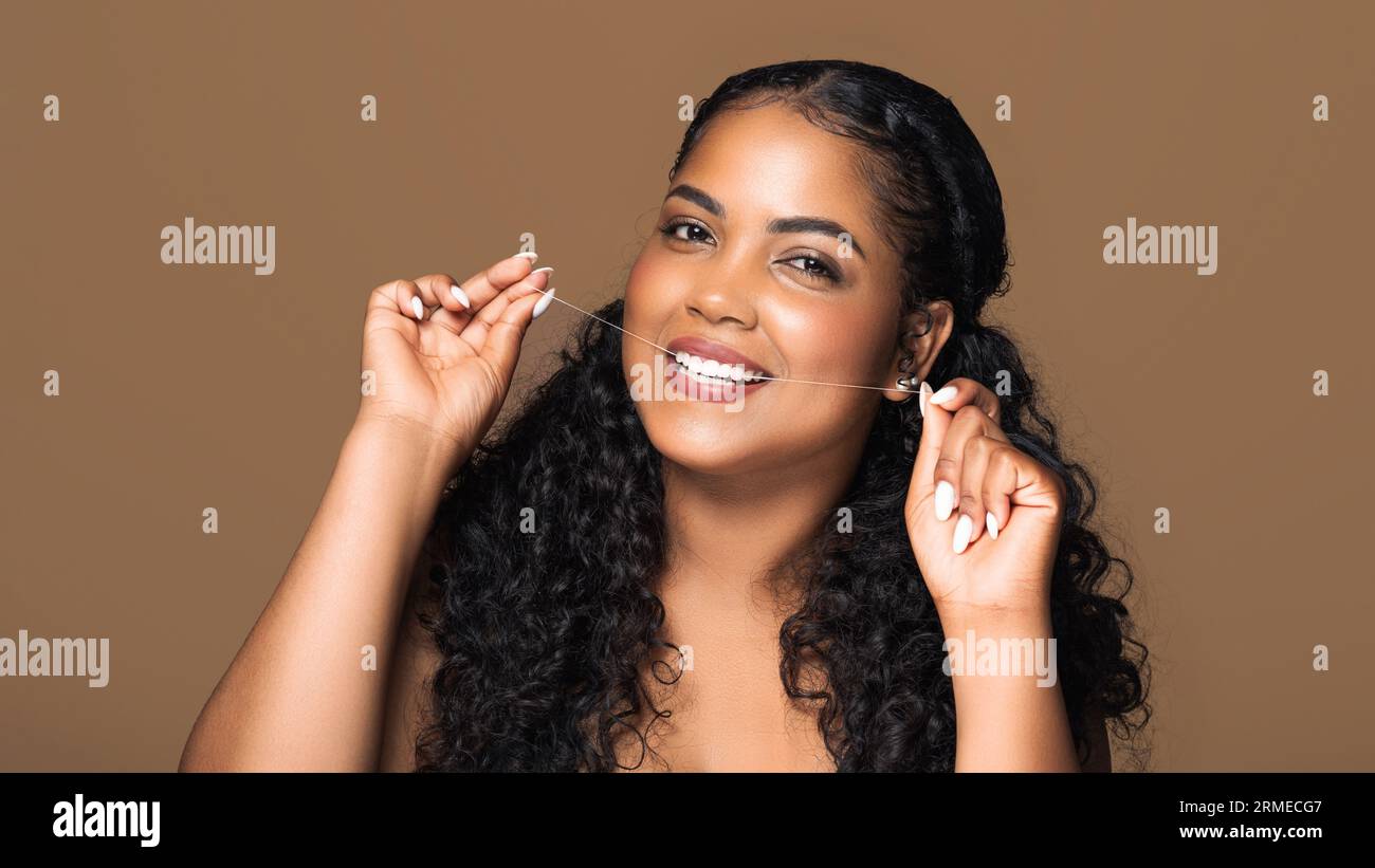 Beautiful Latin Chubby Woman Holding Dental Floss Cleaning Teeth With
