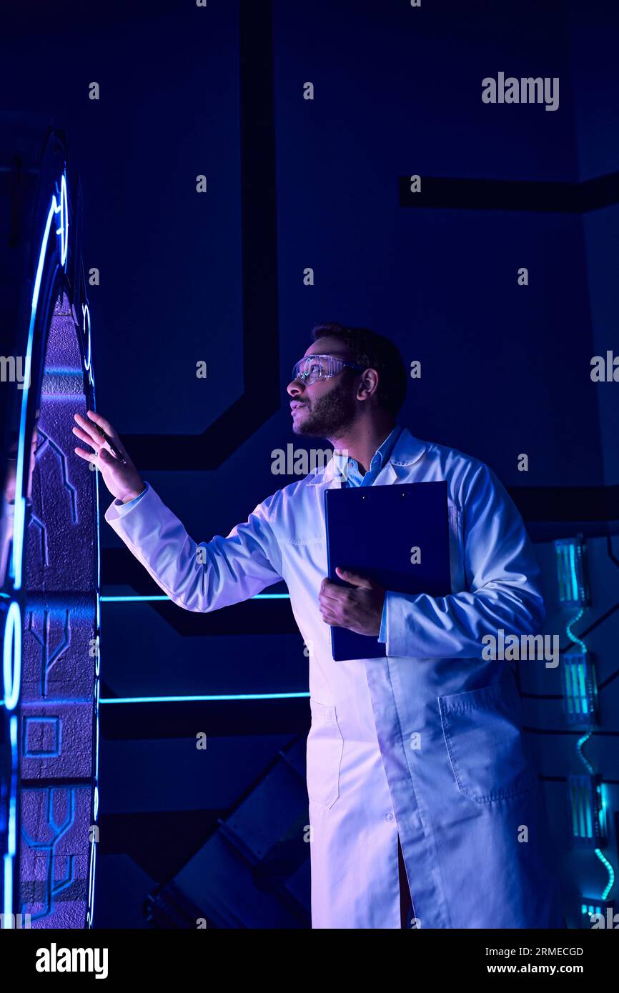 future science, indian scientist in goggles examining new equipment in ...