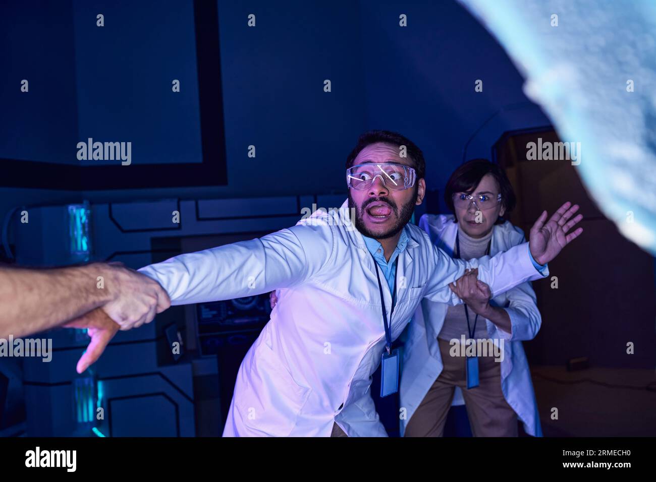 hand from experimental device pulling scared indian scientist in ...