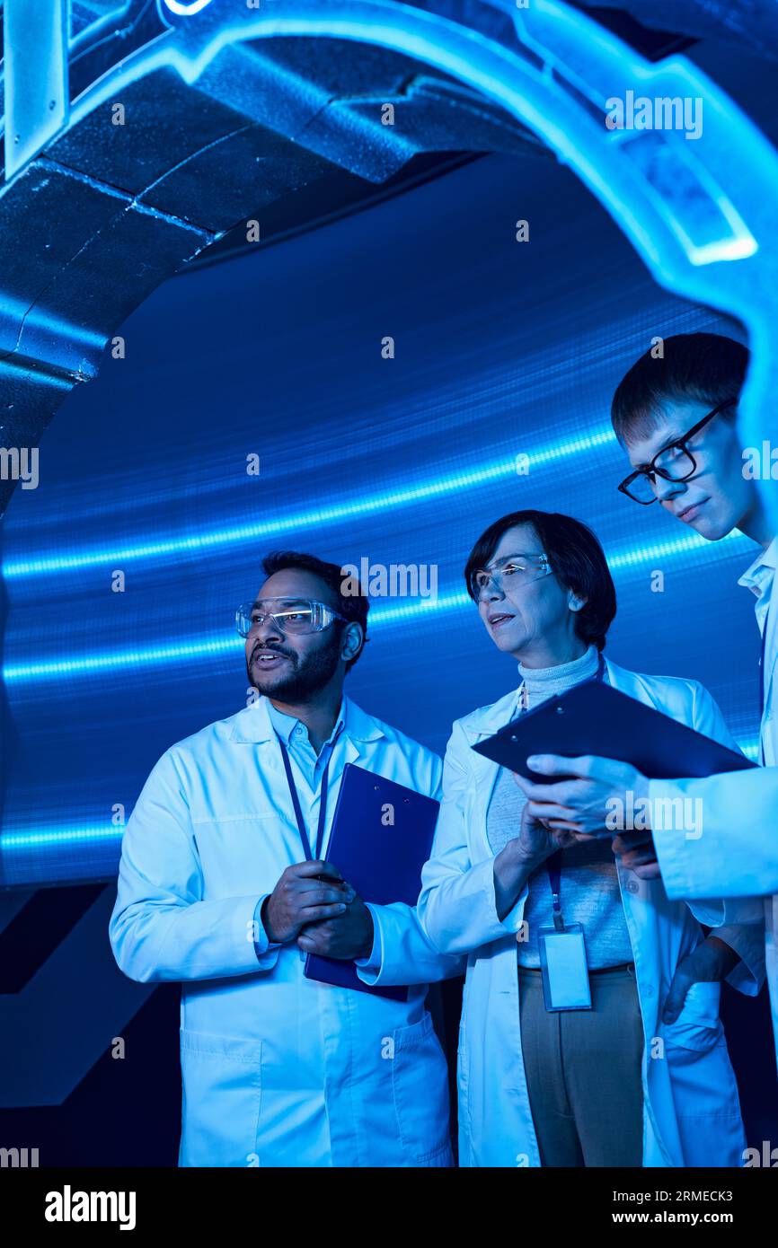 futuristic research, multiethnic scientists examining experimental ...