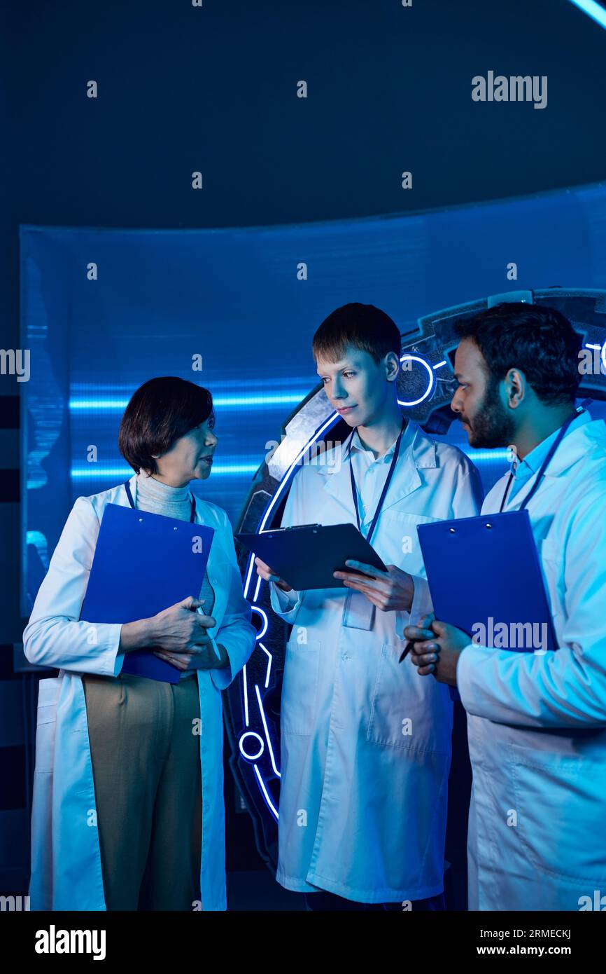 Two scientists and an intern collaborate at a futuristic research ...