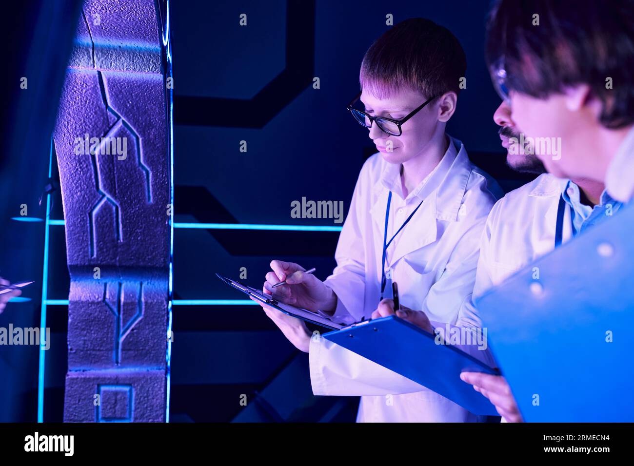 Futuristic Collaboration: Diverse-Age Scientists Work Near Device in ...