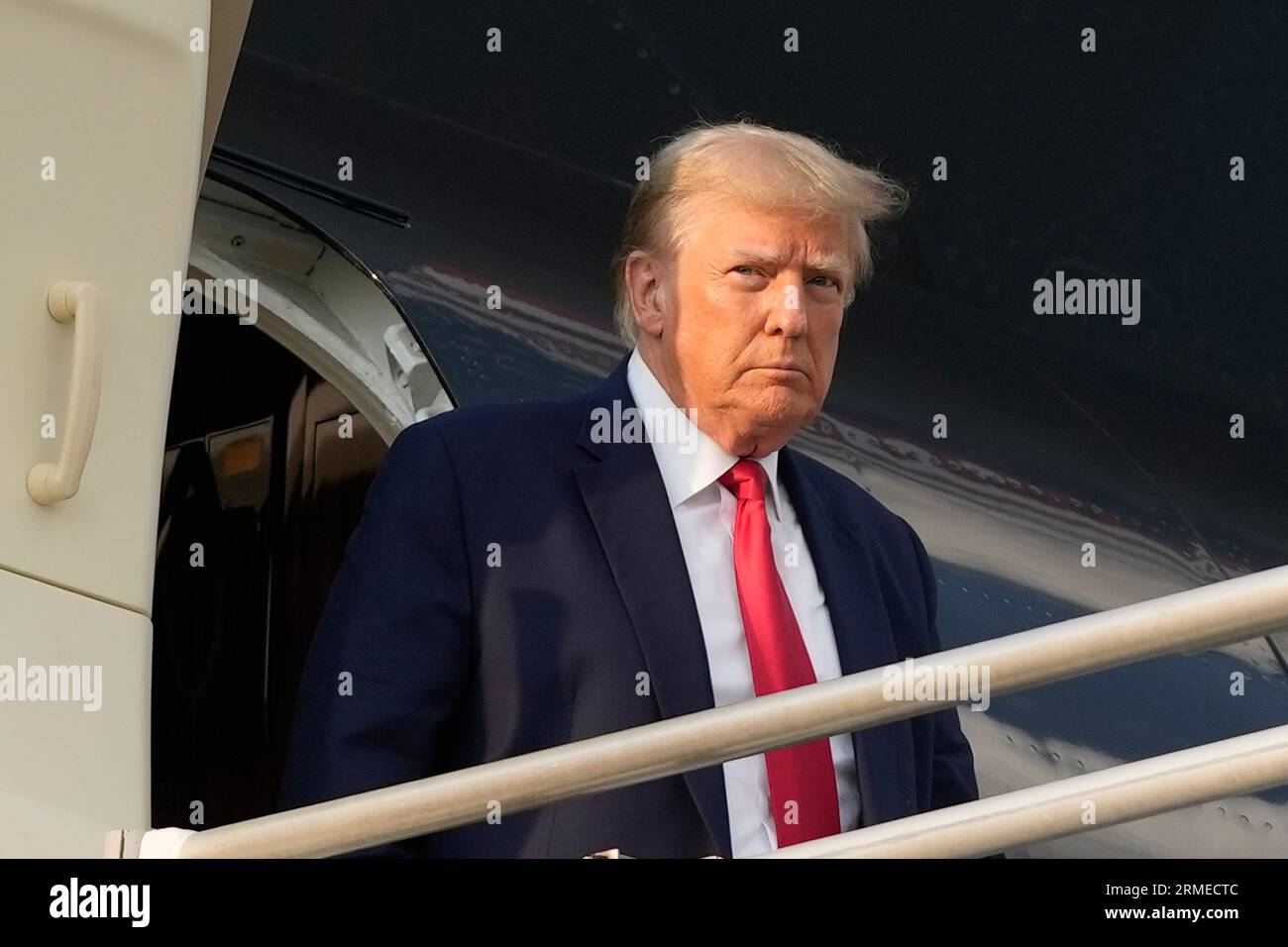 FILE - Former President Donald Trump steps off his plane as he arrives ...