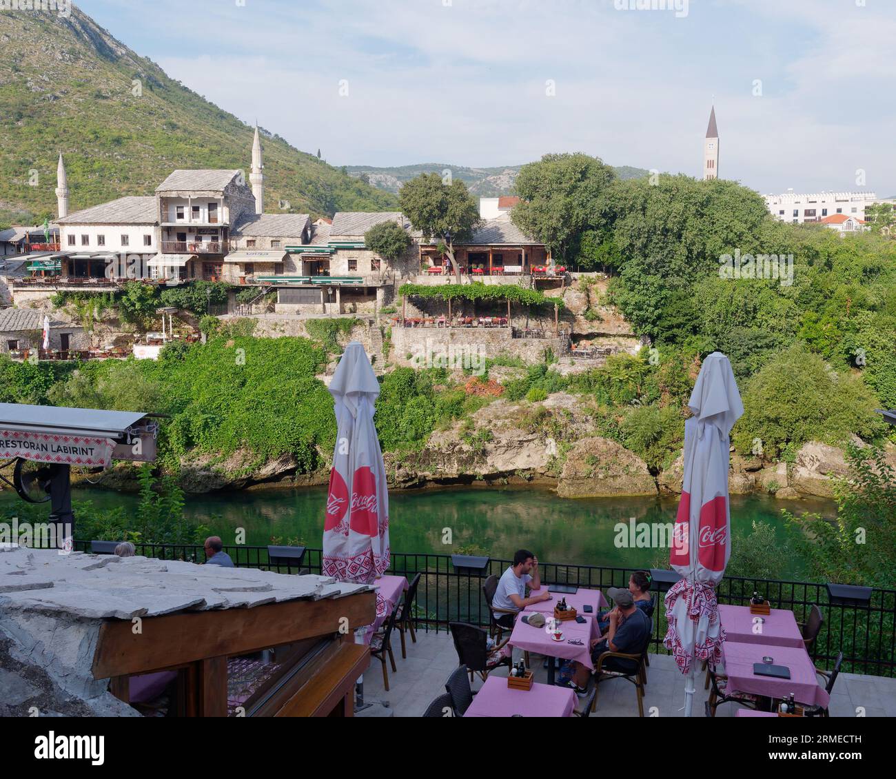 Visitors in a cafe/restaurant overlooking the river Neretvai n the city ...