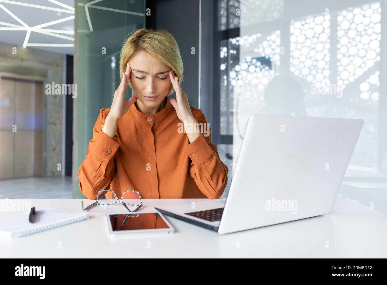 Tired woman at workplace having severe headache, depressed female ...