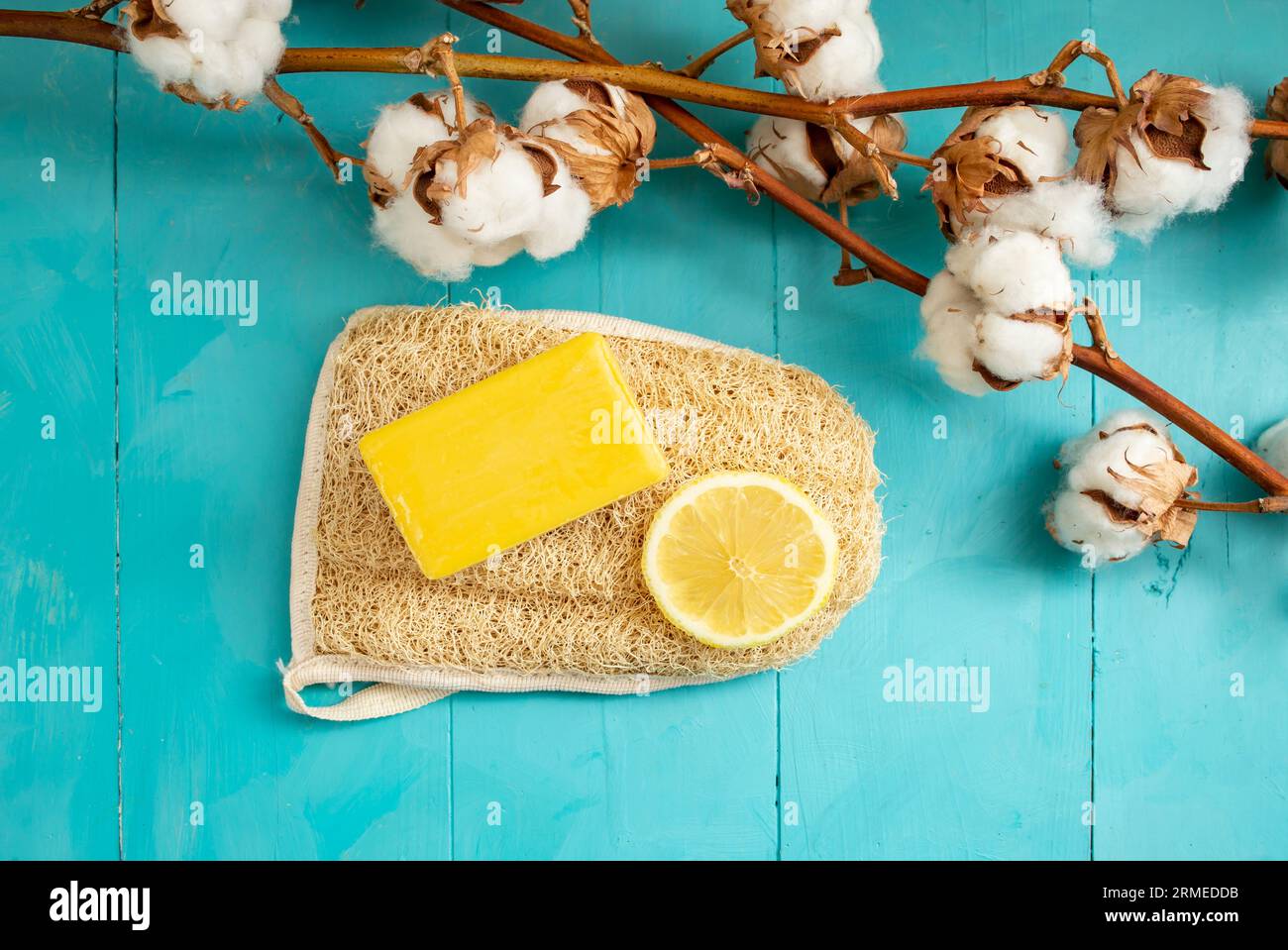 Lemon soap and lemon slice on a loofah bath scrub with cotton buds ...