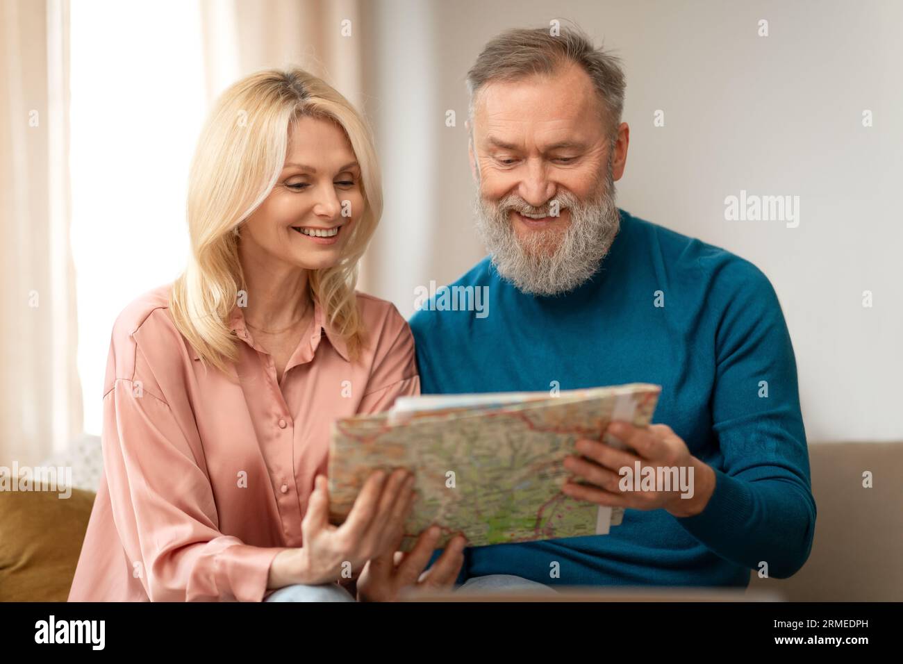 Cheerful Senior Couple Holding Paper Travel Map, Planing Vacation ...